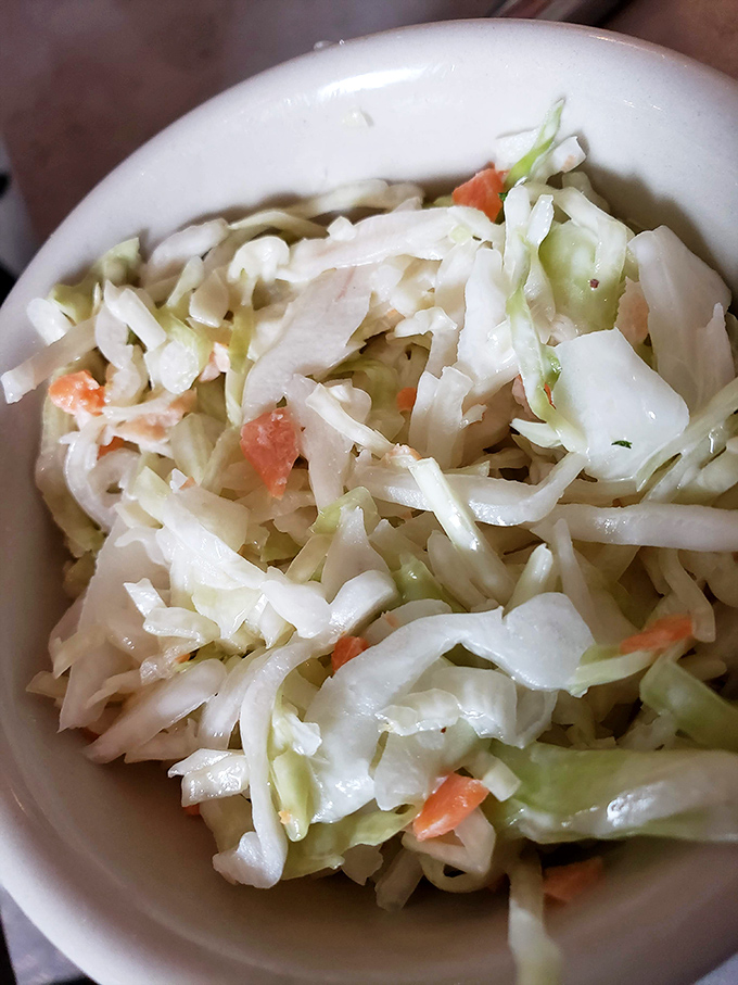 Even the coleslaw deserves its moment in the spotlight – crisp, fresh, and the perfect cool counterpoint to all that smoky meat.