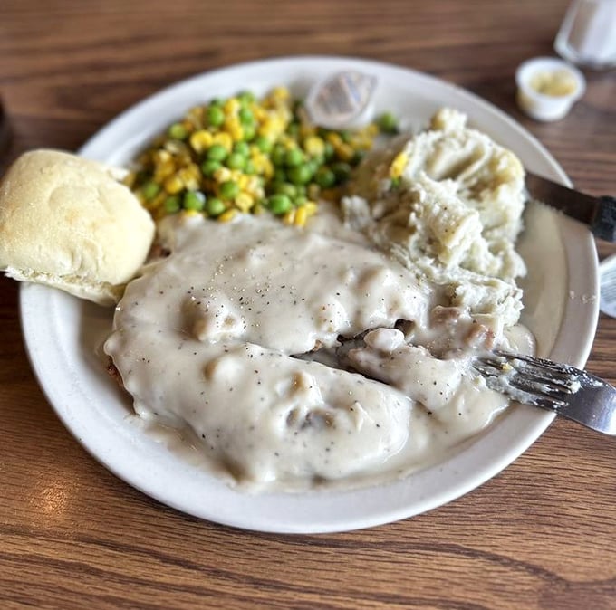 Country fried steak swimming in creamy gravy&mdash;where the fork meets the plate and all your diet resolutions wave the white flag of surrender.