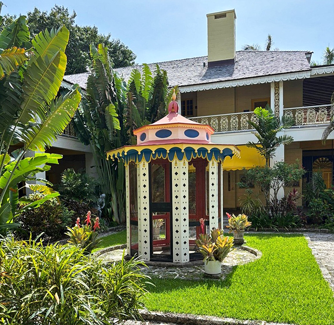 The carousel gazebo looks like it was plucked from a Wes Anderson film set, its candy-colored charm a delightful surprise amid the greenery.