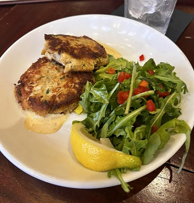 Crab cakes so delicate and perfectly golden, they practically shimmer with coastal charm and flavor.