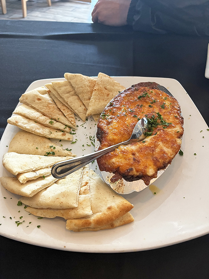 Bubbling crab dip with warm pita triangles&mdash;the kind of shareable that nobody actually wants to share. 