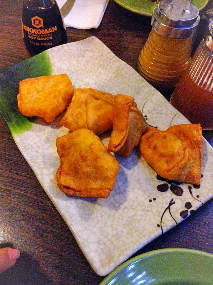 Crab rangoons that shatter with that perfect crunch before revealing their creamy interior—like little fried pillows stuffed with happiness.