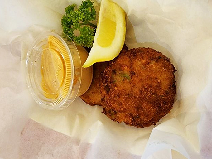 The humble crab cake, elevated to art form &ndash; golden-brown exterior giving way to sweet, delicate meat that tastes like ocean poetry.