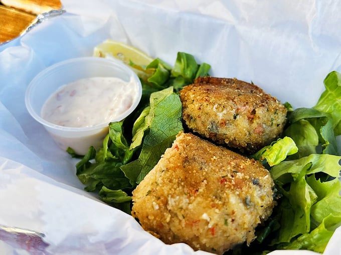 Golden-crusted treasures from the deep. These crab cakes prioritize what matters most &ndash; actual crab &ndash; served with just enough accompaniments to enhance, never mask.
