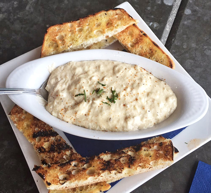This crab dip isn't playing fair&mdash;golden-brown toast flanking a creamy sea of flavor that makes sharing feel like a personal sacrifice.