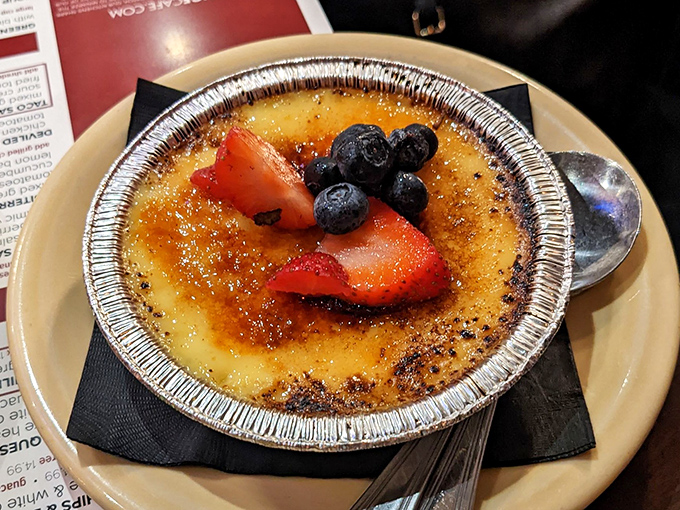 Cr&egrave;me br&ucirc;l&eacute;e with that perfect glass-like sugar crust that makes the most satisfying crack when your spoon breaks through. Berry garnish adds a touch of virtue.