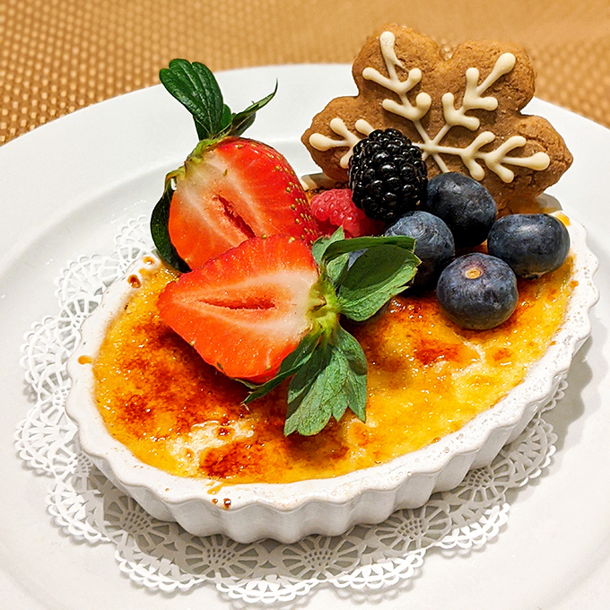 Cr&egrave;me br&ucirc;l&eacute;e with a perfectly torched sugar crust, crowned with fresh berries and a snowflake cookie&mdash;winter's most elegant dessert, regardless of the season.