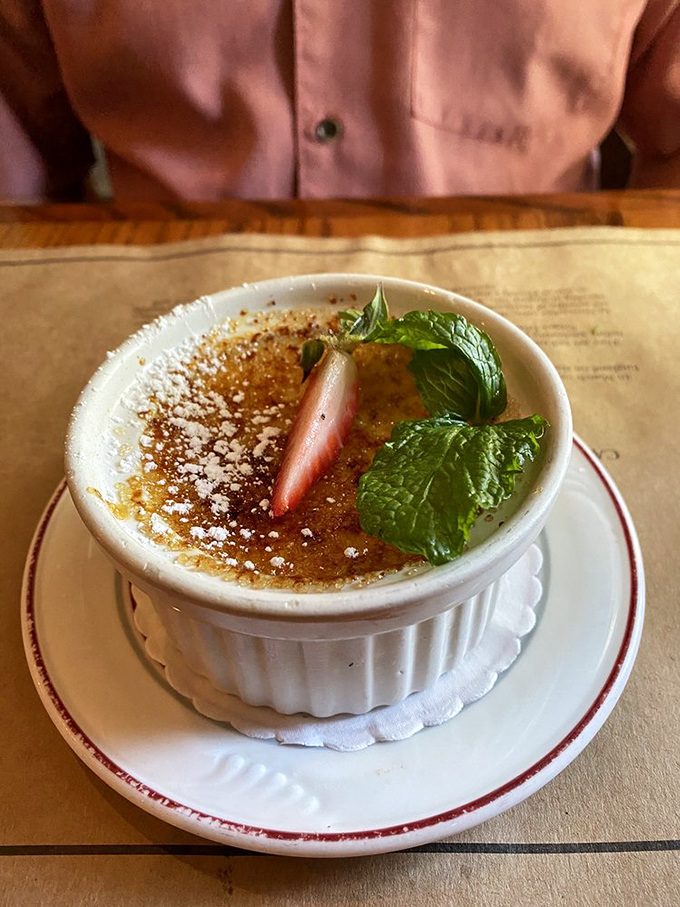 Cr&egrave;me br&ucirc;l&eacute;e with that perfect glass-like sugar top waiting to be cracked. The strawberry and mint garnish aren't just pretty faces &ndash; they're palate cleansers.