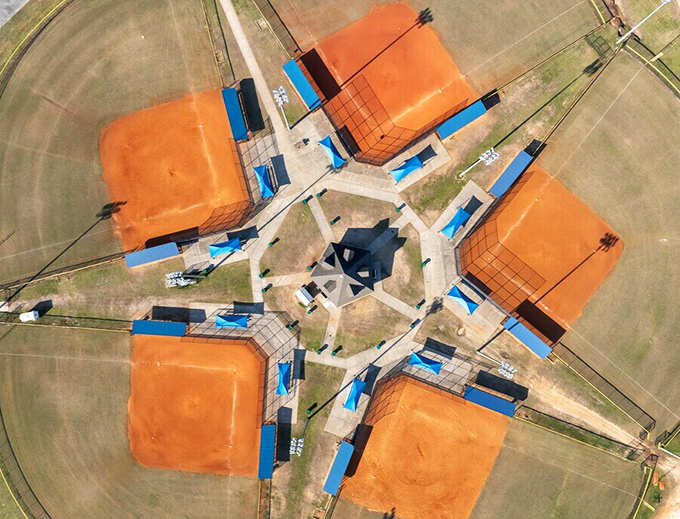 From above, Crisp County's Youth Ball Complex resembles a giant orange pinwheel, where future baseball legends take their first swings at greatness.