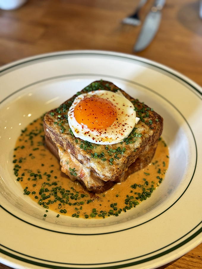 Not your average brunch dish—this Croque Madame with its perfectly fried egg and rich sauce is what breakfast dreams about at night.