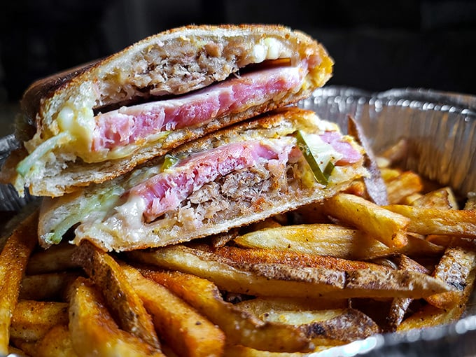 A Cuban sandwich that could make Hemingway weep with joy, paired with fries so perfectly golden they deserve their own Instagram account.