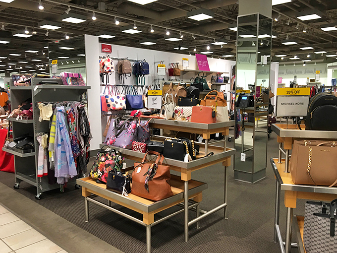 Not just a store, but a museum of possibility &ndash; Michael Kors handbags arranged with the precision of a high-stakes game of Tetris.