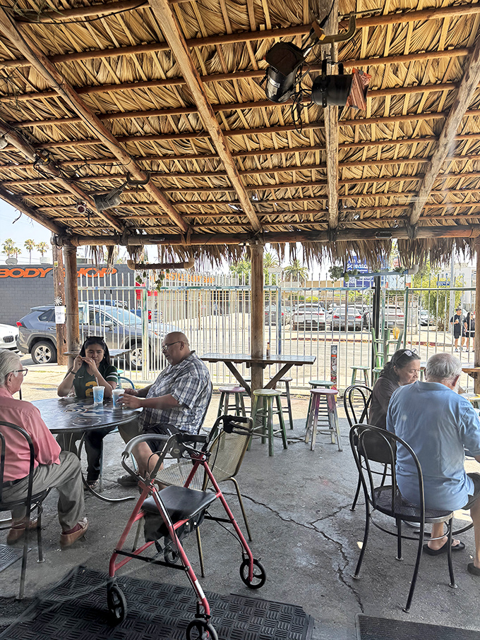 The palapa-covered patio hosts a democratic dining experience where everyone from celebrities to students shares the universal language of tacos.