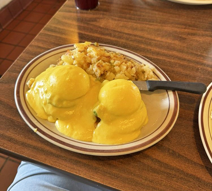 Eggs Benedict with hollandaise so yellow it could stop traffic on Sunset Boulevard, paired with home fries that deserve their own fan club.