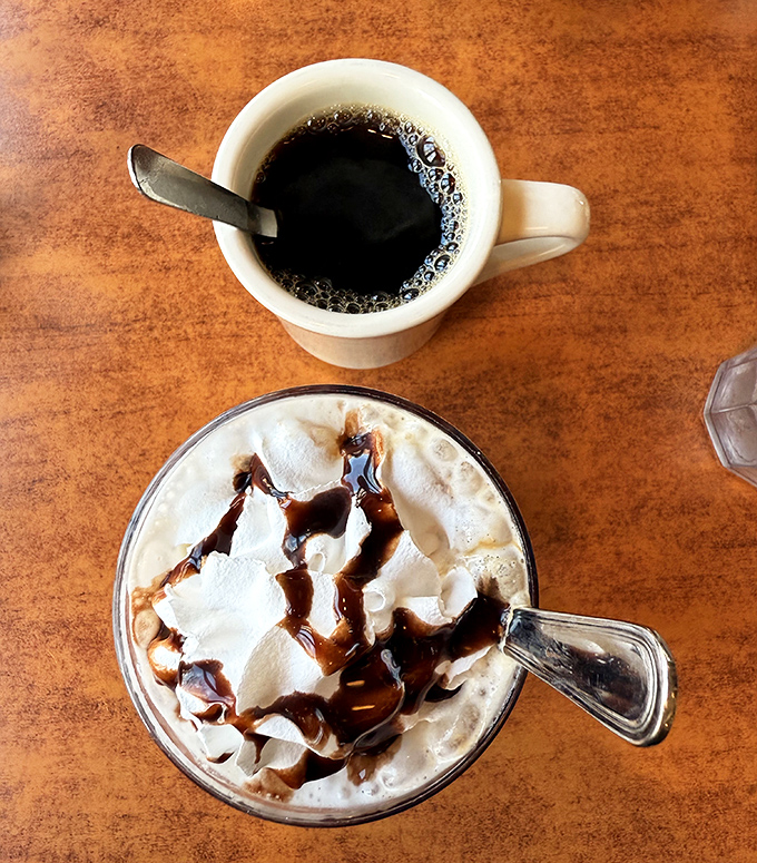 The diner coffee ritual: one cup for now, one mocha for later. The caffeine equivalent of having your cake and drinking it too.