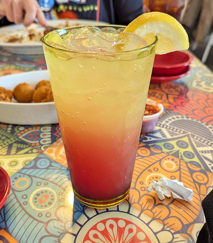 A sunset in a glass—this colorful layered drink offers a refreshing counterpoint to the hearty comfort food classics.