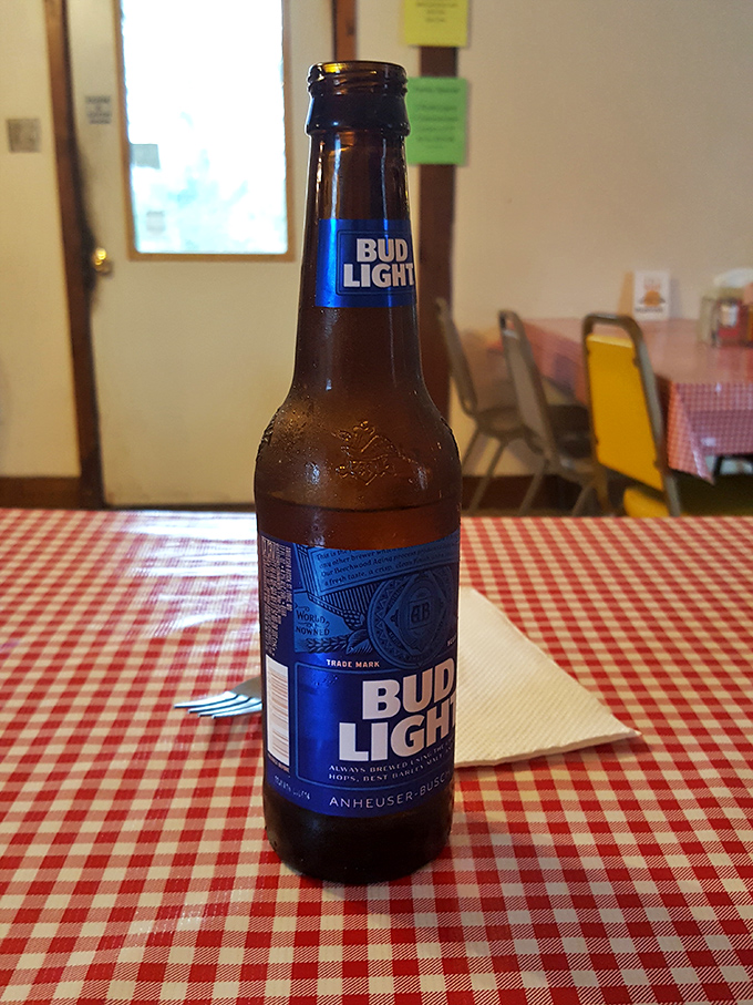 A cold Bud Light on a checkered tablecloth&mdash;sometimes the simplest pleasures perfectly complement honest, unpretentious food.