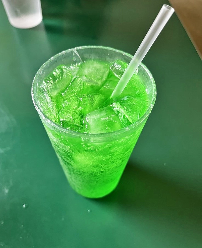 The electric green phosphate fizzes with nostalgic charm. One sip and you're transported to a time when soda fountains were social media and straws came unwrapped.