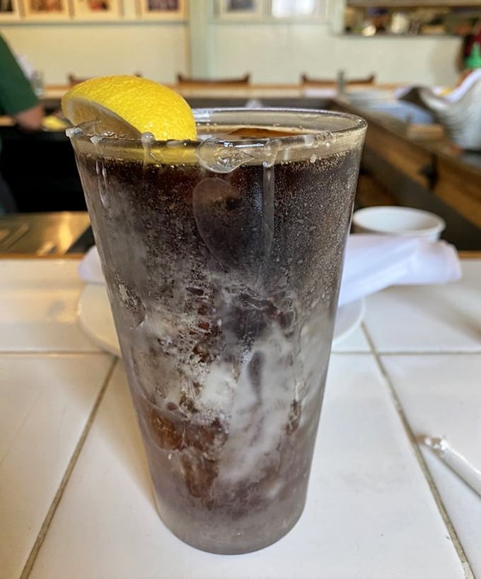 A tall, frosty glass of something refreshing with a lemon garnish. Because after all that seafood, your palate deserves a crisp intermission.