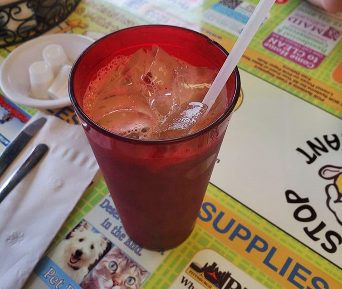 That ruby-red iced tea in its no-nonsense glass isn't just a beverage&mdash;it's the perfect supporting actor in your breakfast blockbuster.