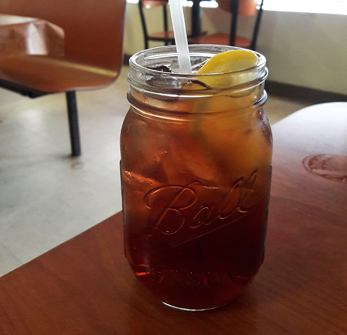 Sweet tea served in a Mason jar with a lemon wedge &ndash; the unofficial state beverage of Florida diners, delivering refreshment with a side of Southern tradition.