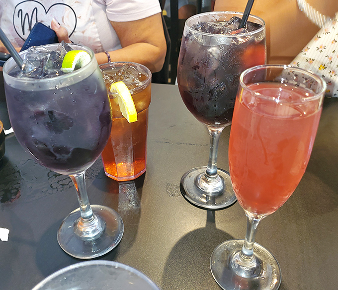 Weekend brunch cocktails lined up like colorful soldiers ready to battle your weekday stress &ndash; the pink one's already winning.