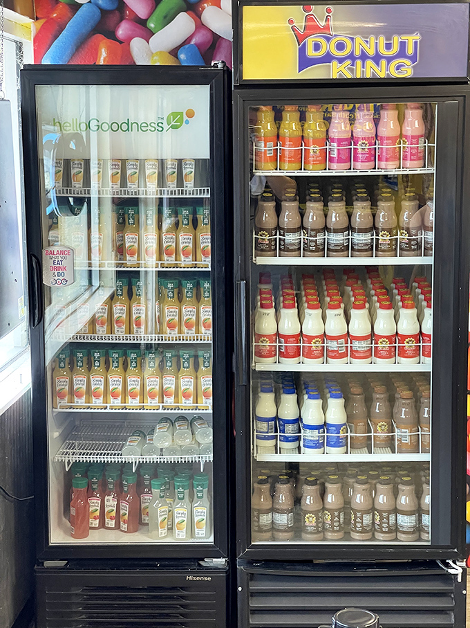 The beverage coolers stand ready like liquid reinforcements, because tackling pastries this magnificent requires proper hydration strategy.