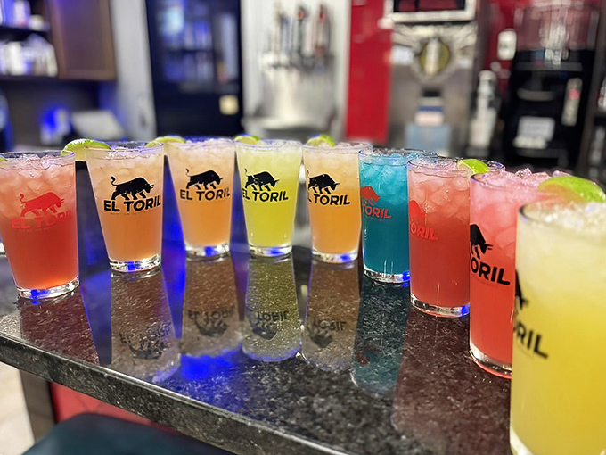 A rainbow of margaritas lined up like edible jewels. Decision paralysis has never been so deliciously complicated.