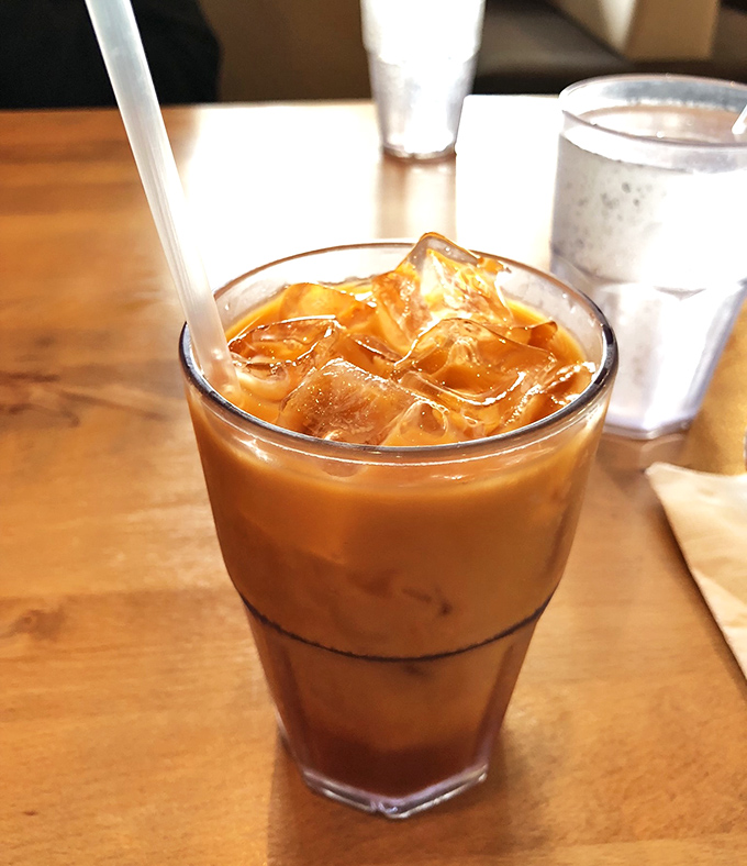 Thai iced tea: where caffeine meets condensed milk in a glass of amber perfection. Refreshment that doubles as dessert.