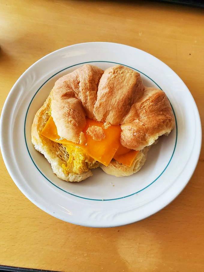 The humble breakfast croissant, elevated to art form&mdash;golden, flaky exterior giving way to melted cheese and egg that makes morning meetings almost bearable.