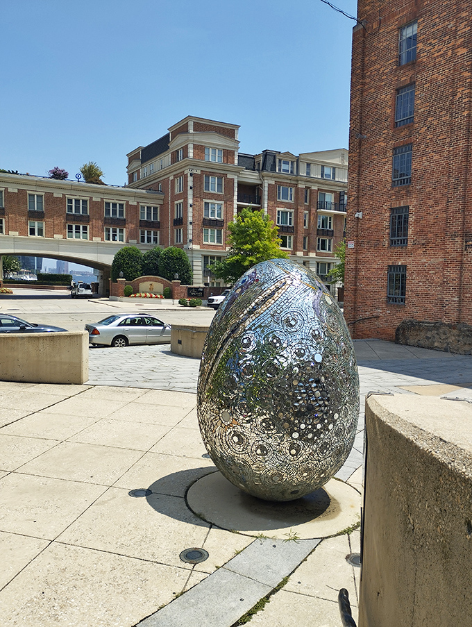 This mirrored egg sculpture reflects everything around it, creating infinite variations depending on where you stand. Like a cosmic Easter egg left by some playful universe-creator.