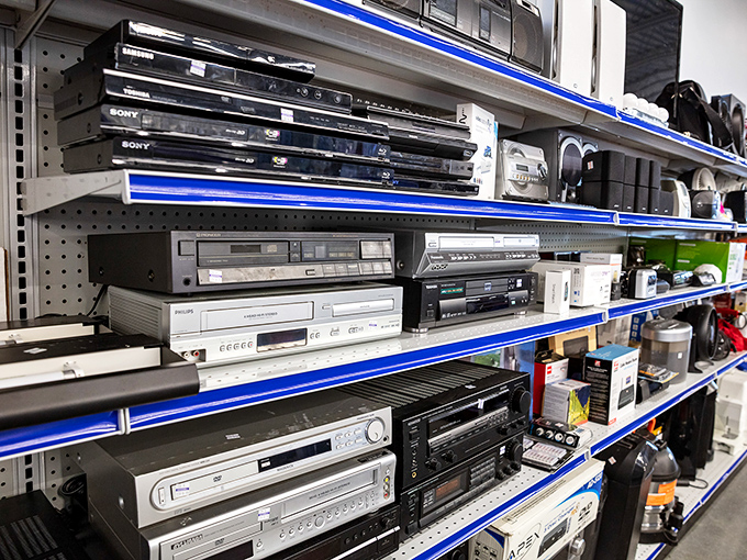 The electronics section—a time capsule of technological evolution where DVD players and VCRs enjoy their retirement alongside more recent digital refugees.