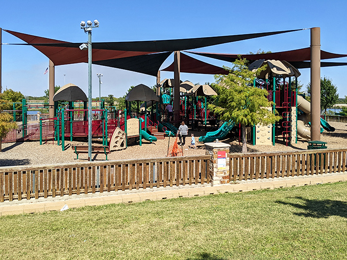 Elmer Thomas Park's playground offers shaded fun for visiting grandchildren, because nothing says "cool grandparent" like knowing where the best slides are.