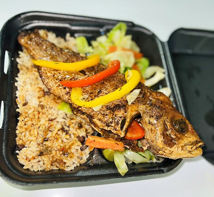 Escovitch fish: where a whole snapper gets dressed up in peppers and onions like it's heading to the Caribbean's most delicious party.