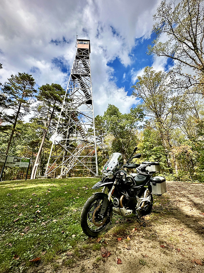 The fire tower stands like a sentinel from another era, rewarding brave climbers with panoramic views worth every step.