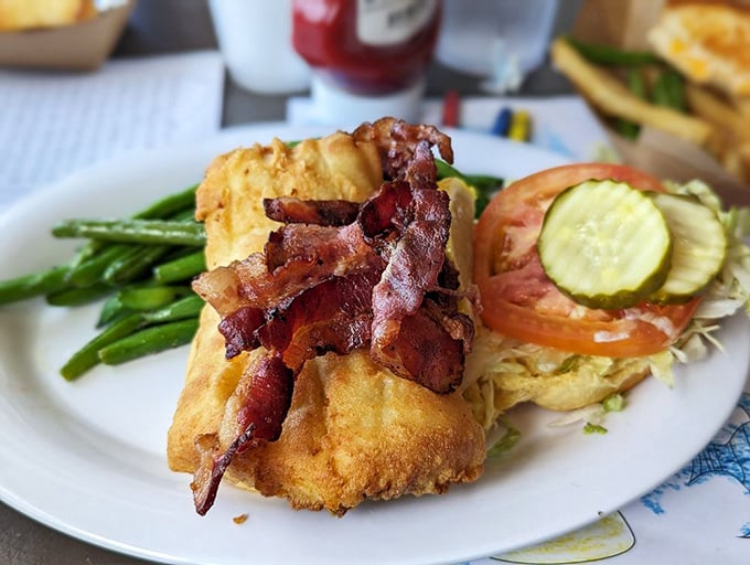 This isn't just a sandwich&mdash;it's architecture. Crispy flounder, bacon, and fresh veggies stacked like the seafood version of the Chrysler Building.