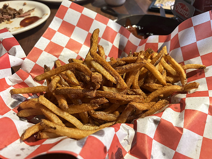 French fries with that perfect golden-brown hue, seasoned just enough to stand on their own but humble enough to complement the BBQ star of the show.