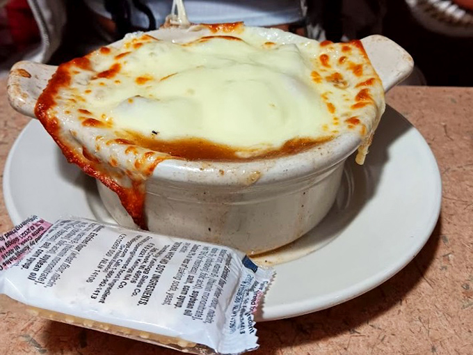 French onion soup that's achieved the impossible trifecta: perfectly caramelized onions, rich broth, and a cheese cap that stretches dramatically with each spoonful.