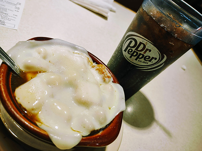 French onion soup under a blanket of melted cheese &ndash; the ultimate comfort food that warms you from the inside out like a culinary hug.