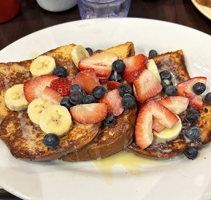 French toast that's living its best life under a mountain of fresh fruit. Breakfast or dessert? At this point, who's keeping score?