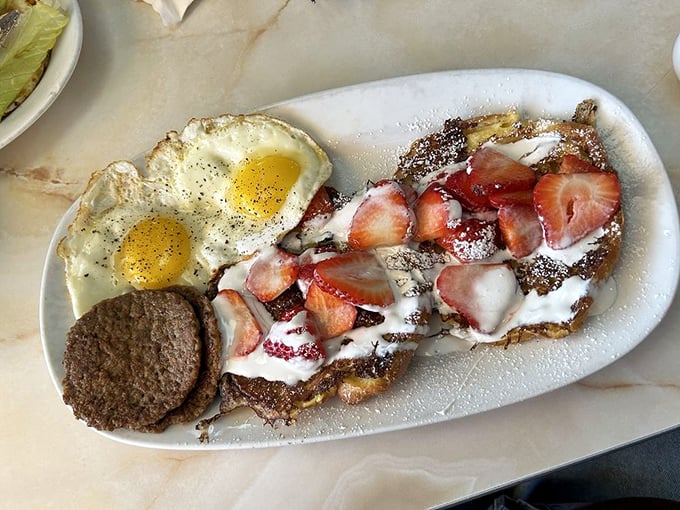 French toast topped with strawberries and powdered sugar proves breakfast desserts should absolutely be a legitimate food group.