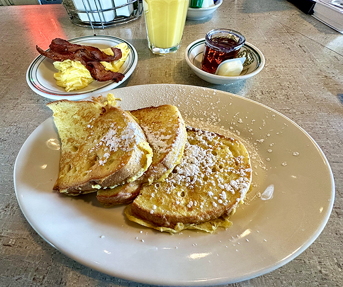Golden French toast with the works. That powdered sugar dusting is like fresh snow on a perfect morning – beautiful and fleeting.