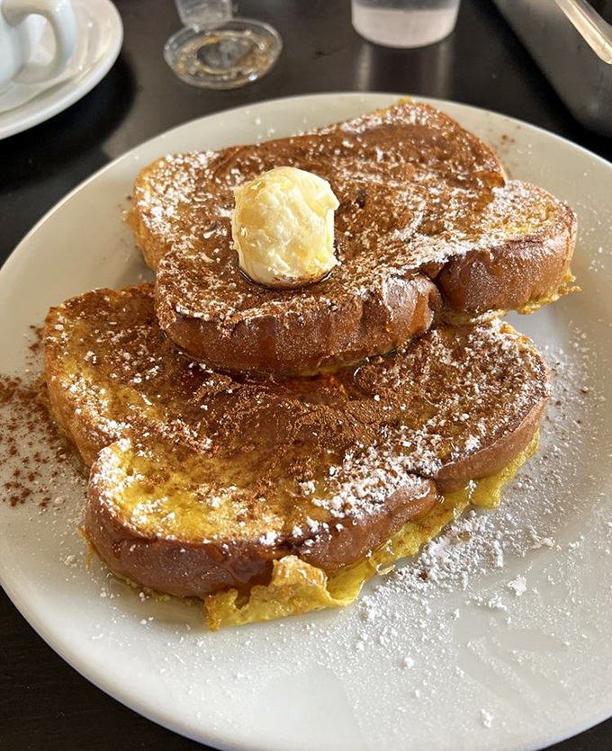 French toast that's dressed for success with powdered sugar snow and a butter hat. Breakfast or dessert? The line deliciously blurs.