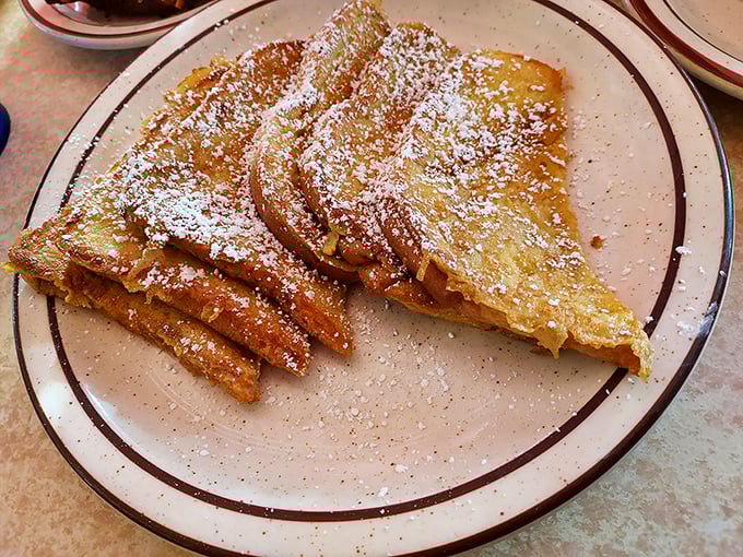 French toast dusted with powdered sugar like fresh snow on a winter morning&mdash;breakfast that doubles as dessert.