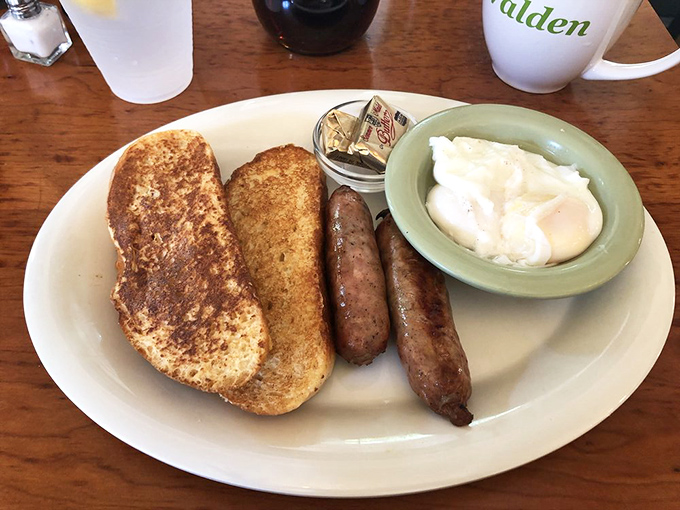 Breakfast sausage links standing at attention next to golden toast and poached eggs&mdash;the morning equivalent of a perfectly tailored suit.
