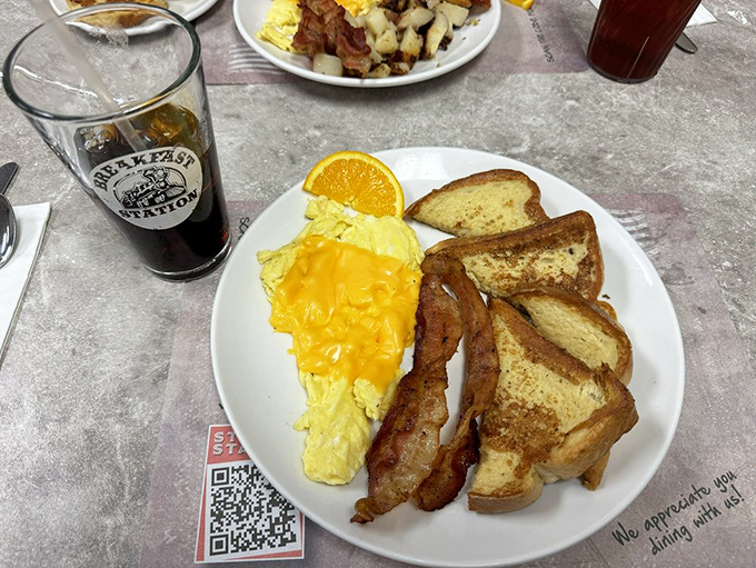 French toast that's achieved that mythical golden-brown exterior while maintaining custardy softness inside. Paired with perfectly cooked bacon, it's the breakfast equivalent of hitting the lottery.