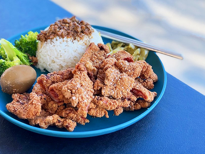 Crispy fried pork that would make your cardiologist nervous but your taste buds ecstatic. That mountain of rice isn't just a suggestion.