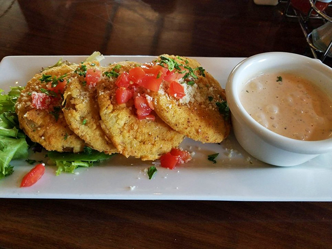 Fried green tomatoes dressed for success &ndash; crispy coating giving way to tangy perfection that defines Southern sophistication.