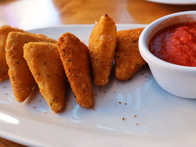 Fried mozzarella triangles standing at attention, ready for their marinara bath. Geometry has never been this delicious or worth the heartburn.