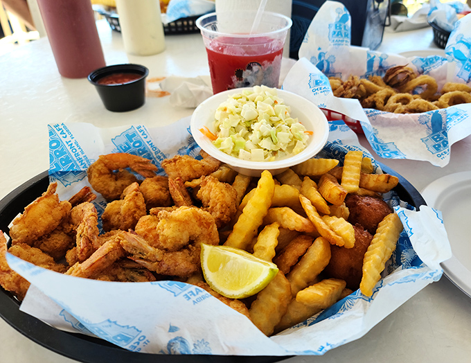 A seafood medley that makes choosing unnecessary&mdash;fried shrimp, fish, hushpuppies, and those curly fries that somehow improve everything they touch.